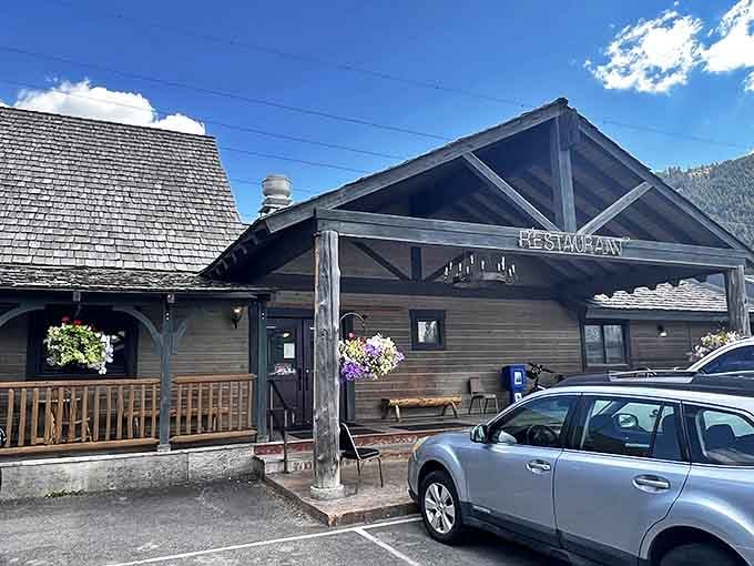 The Virginian's rustic wooden exterior stands like a defiant time capsule against Jackson's luxury backdrop, complete with charming hanging flower baskets.