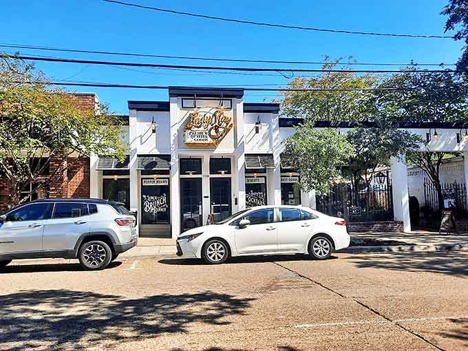Lady May&rsquo;s illuminated storefront welcomes early visitors like a beacon, inviting hungry souls to enjoy coastal charm blended with urban style in Ocean Springs.