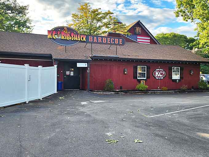 The red barn exterior of KC's isn't just charming—it's a smoke signal to barbecue lovers that serious flavor awaits inside this Manchester meat sanctuary.