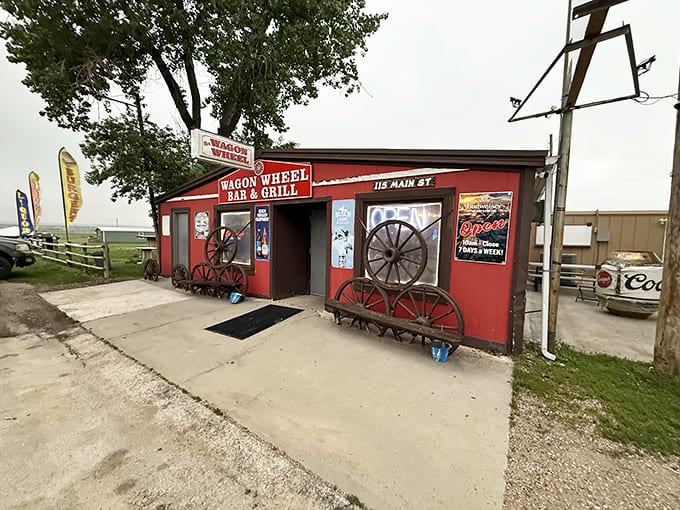 The bright red exterior of Wagon Wheel Bar & Grill stands as a beacon of hope for hungry travelers, complete with authentic wagon wheels that aren't just for show.