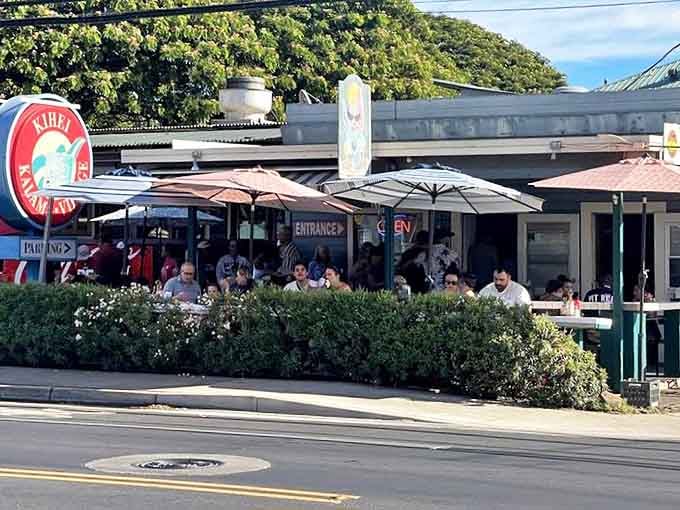 The unassuming exterior of Kihei Caffe might fool you, but that line of hungry patrons tells the real story. Paradise awaits under those red umbrellas.