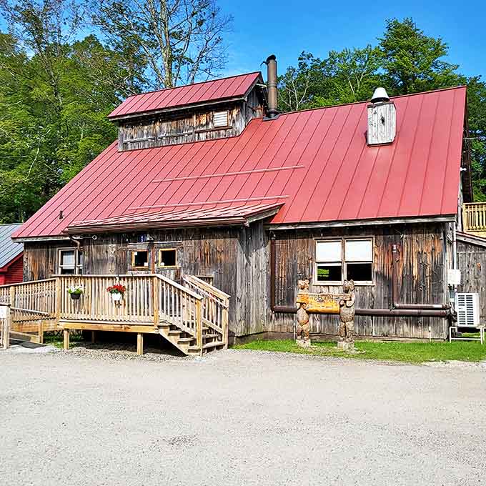 The classic sugar house silhouette stands proudly against summer greenery, its wooden stairs inviting you into a world where breakfast dreams come true.