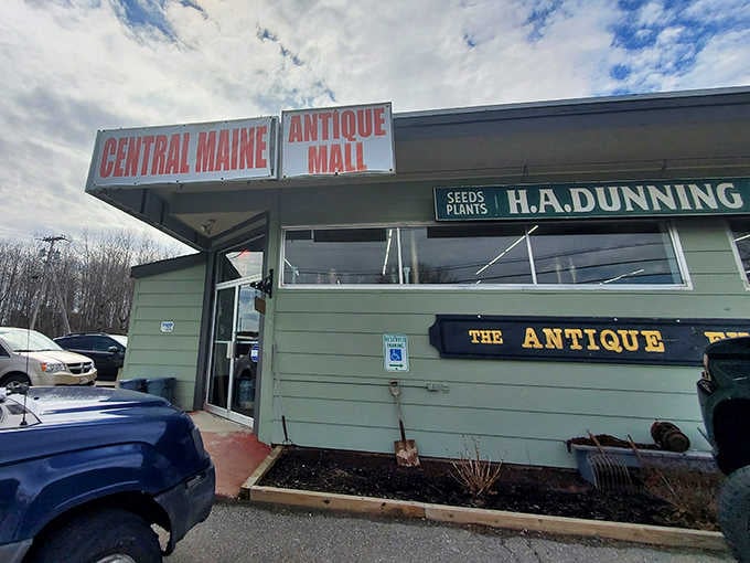 The welcoming facade of Central Maine Antique Mall, where vintage treasures await behind this unassuming green exterior.