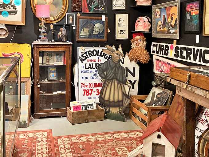 A treasure hunter's dream corner featuring vintage signage, quirky figurines, and that rabbit-headed statue that's either delightfully whimsical or tonight's nightmare fuel.