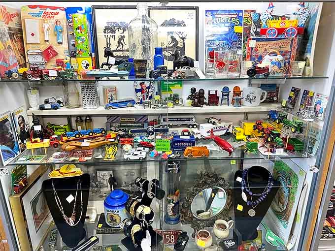 Treasure hunters, behold! This glass case is a time machine disguised as a display, where Hot Wheels meet vintage action figures and childhood memories come flooding back.