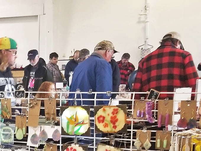Treasure hunters gather around handcrafted earrings, their faces showing that unmistakable "I-might-have-found-something" glow that makes flea markets magical.