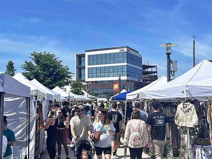 Crowds weave through the Providence Flea's white tents, hunting for vintage treasures and handcrafted goods on a perfect summer day.