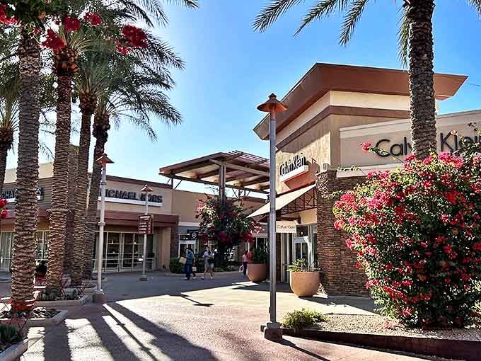 Desert shopping paradise where palm trees and designer discounts live in perfect harmony. Calvin Klein beckons while vibrant bougainvillea adds splashes of color to your bargain hunt.