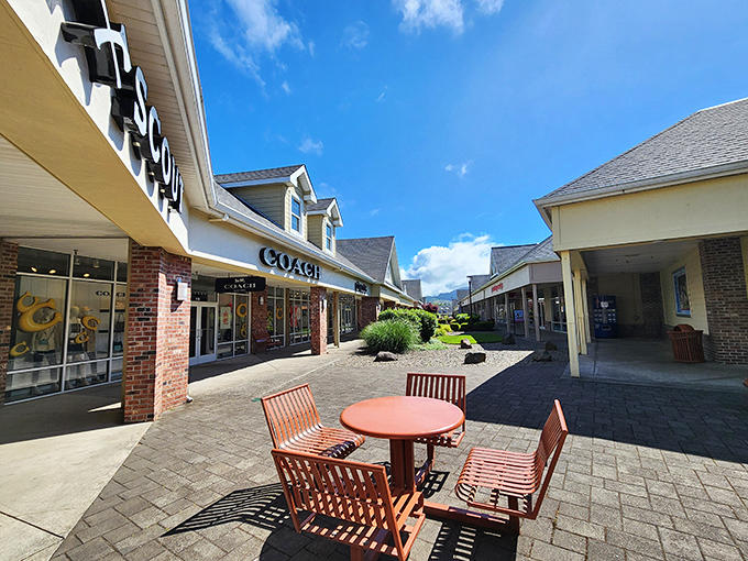 A peaceful courtyard with wooden seating invites weary shoppers to rest their bags and contemplate their next retail conquest.