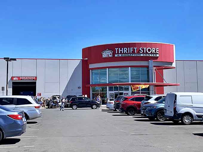 The distinctive red signage of arc Thrift Store welcomes bargain hunters with the promise of treasures waiting inside.
