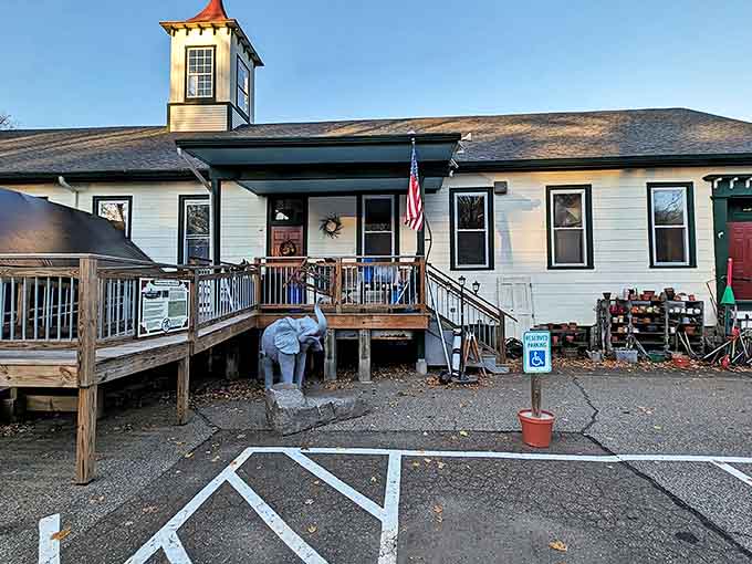 The white clapboard building with its distinctive red-capped cupola stands like a lighthouse for bargain hunters navigating the sea of retail sameness.