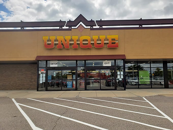 The iconic yellow-orange Unique sign beckons like a lighthouse for bargain hunters. Thrifting adventures begin at this unassuming storefront.