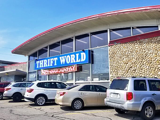 The distinctive curved roof and bold blue signage of Thrift World beckons bargain hunters like a retail lighthouse. Cars in the lot suggest others have already discovered this treasure trove.