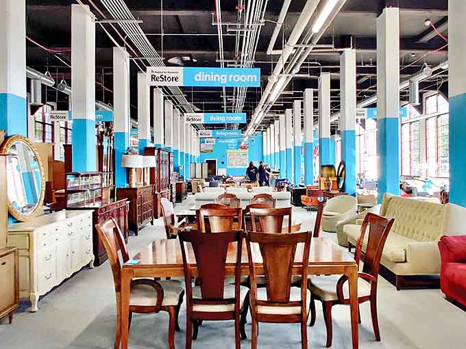 Organized chaos at its finest – where Adirondack chairs mingle with dining sets under the watchful gaze of blue-painted columns.