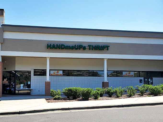 HandmeUPs Thrift sits unassumingly in a strip mall, like a treasure chest disguised as an ordinary box. The teal signage promises adventures in bargain hunting.