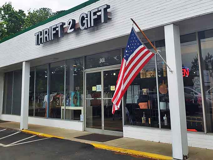 Another view of Thrift2Gift's storefront, where bargain hunters begin their quest. The flag says "patriotism," the windows whisper "possibilities."