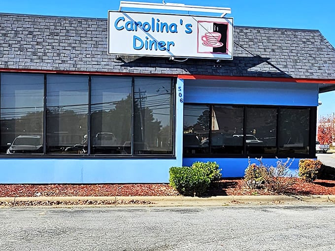 The blue and white exterior of Carolina's Diner stands as a beacon of hope for hungry travelers &ndash; a promise of honest food without pretension.