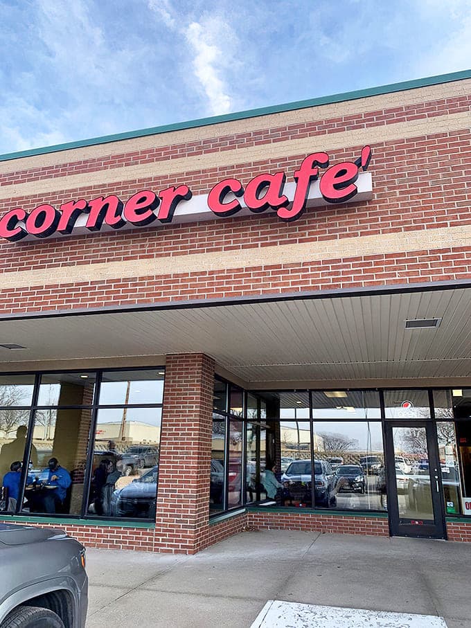 The iconic red signage of Corner Cafe stands out against the brick facade like a beacon for hungry travelers seeking honest-to-goodness Iowa comfort food.