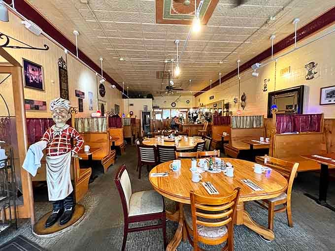 The classic diner aesthetic at Snap's Restaurant welcomes you with wooden booths, vintage ceiling tiles, and a chef statue standing guard &ndash; comfort before you even taste the food.