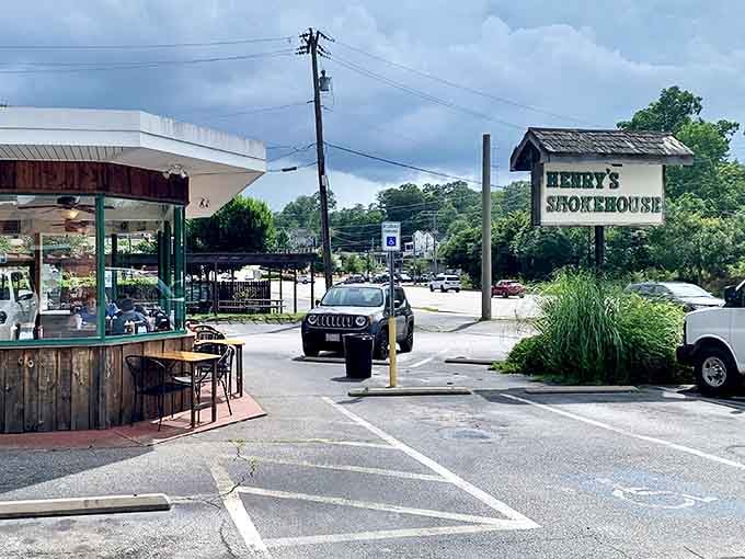 A view of Henry's Smokehouse from the parking lot reveals its modest setting, where locals and travelers alike make pilgrimages for legendary South Carolina barbecue.