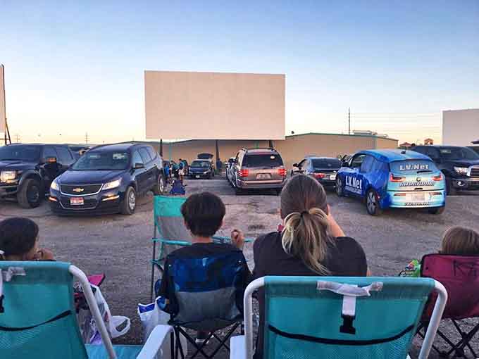 The ultimate movie night setup: lawn chairs, blankets, and a giant screen under the vast Nevada sky. Cinema as it was meant to be experienced.