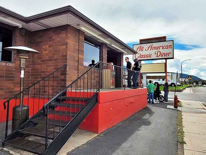 The iconic All American Classic Diner sign beckons hungry travelers like a lighthouse for the famished. Cedar City's culinary landmark stands ready to serve.