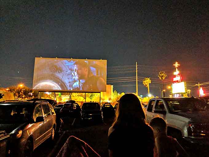 The ultimate movie night setup: lawn chairs, blankets, and a giant screen under the vast Nevada sky. Cinema as it was meant to be experienced.