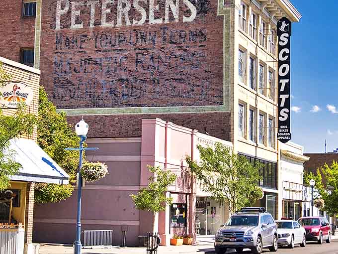 Ghost signs and modern storefronts create Pocatello's perfect time-travel experience. The faded Petersen's advertisement reminds us that before Instagram, advertising had serious staying power.