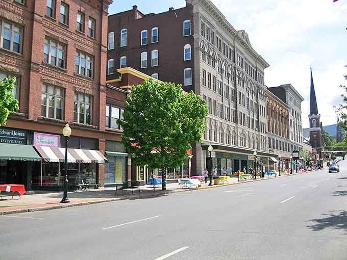 Downtown North Adams showcases classic New England charm with its historic brick buildings and church spires framed against rolling Berkshire hills.
