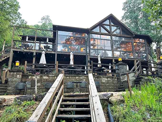Warm lights transform Toccoa Riverside into a glowing lantern perched above the water. Those umbrella-shaded tables are prime real estate during Georgia summers.