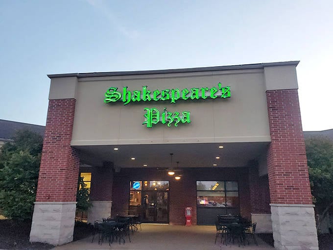The iconic green glow of Shakespeare's Pizza sign welcomes hungry visitors like a beacon of cheesy hope in Columbia's culinary landscape.