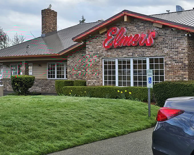 The brick exterior of Elmer's welcomes you like an old friend, complete with that iconic red sign promising comfort without pretension.