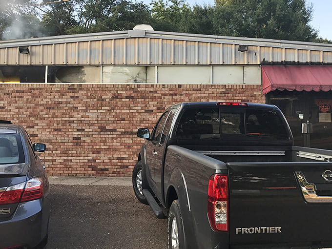 The exterior doesn't need fancy frills when what's happening inside is pure barbecue magic. That red awning might as well be a superhero cape.