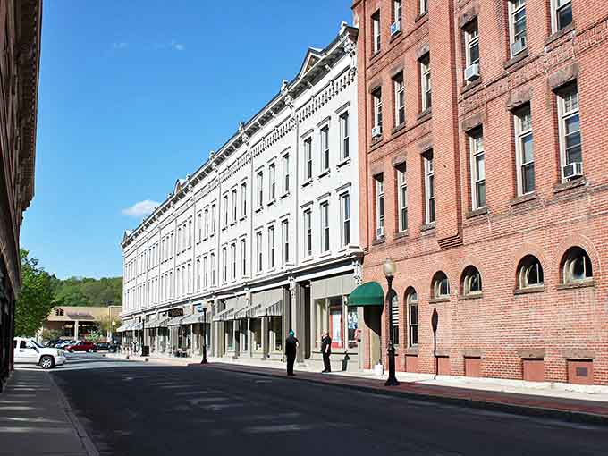 Downtown North Adams showcases classic New England charm with its historic brick buildings and church spires framed against rolling Berkshire hills.