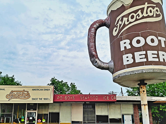 The iconic Frostop mug stands tall against the Louisiana sky, a beacon of hope for those who believe great root beer should always come with a side of nostalgia.