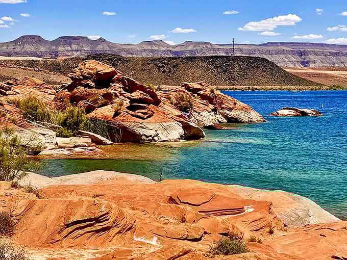 Where azure waters kiss fiery red rocks – Mother Nature's most dramatic love story unfolds at Sand Hollow.