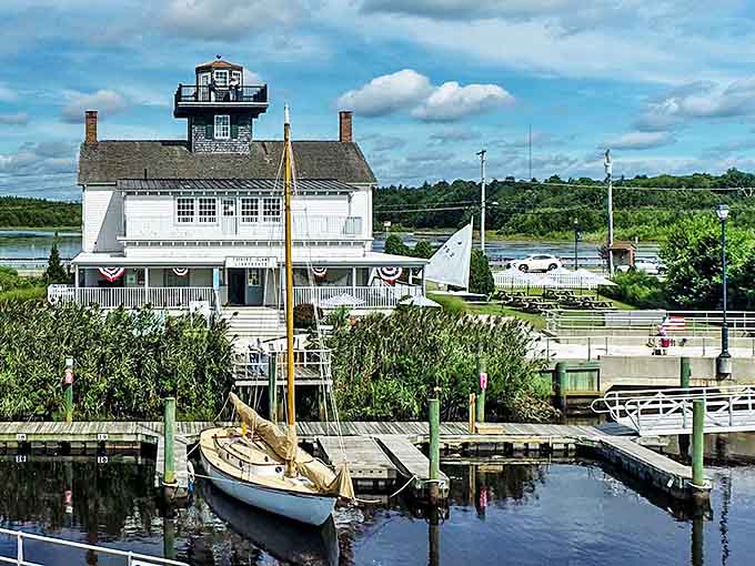 The Tucker's Island Lighthouse stands sentinel over the harbor, where vintage sailboats wait patiently for their next adventure on Barnegat Bay.