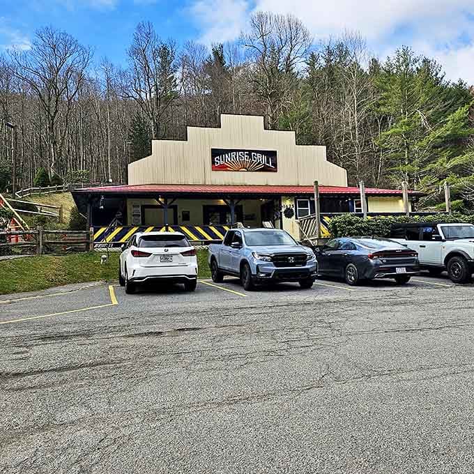 The stepped roofline of Sunrise Grill stands like a mountain range against the Carolina blue sky, promising breakfast adventures within those cheerful blue-and-yellow railings.