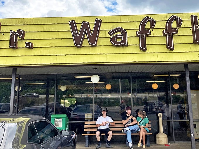 The iconic yellow exterior of Mr. Waffle stands as a beacon of hope for hungry travelers &ndash; where affordable comfort food awaits behind those vintage brown letters.