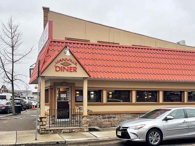The iconic red roof of Manville Diner beckons hungry travelers like a lighthouse guiding ships to safe harbor. Classic Jersey diner architecture at its finest.