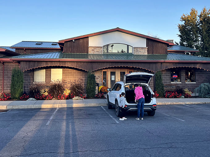 Traditions welcomes visitors with its distinctive stone-and-timber facade, where autumn flowers add splashes of color against the rustic architecture. The perfect small-town restaurant postcard come to life!