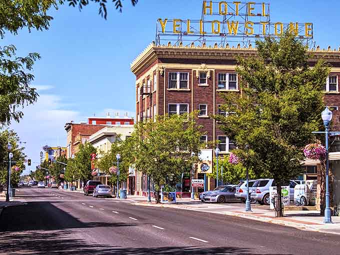 The iconic Hotel Yellowstone sign crowns downtown like a beacon from another era. Beneath it, tree-lined streets and hanging flower baskets create the kind of Main Street that Norman Rockwell would have sketched on his lunch break.