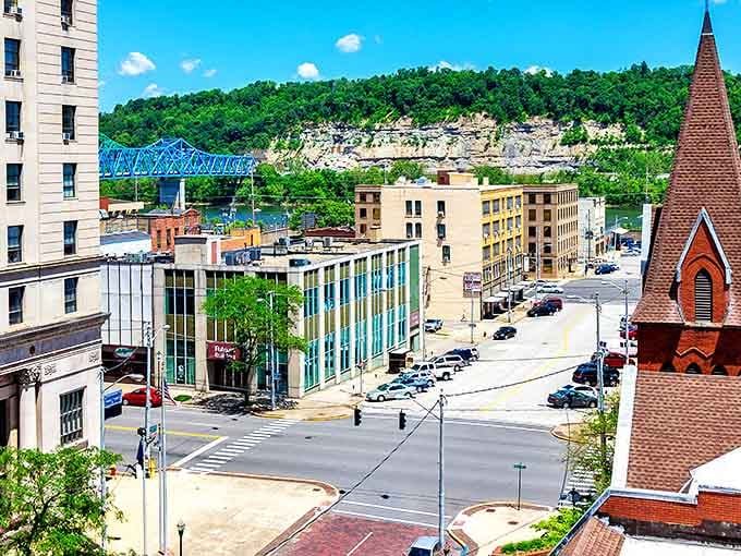 Downtown Ashland unfolds beneath limestone cliffs, with the iconic blue bridge connecting Kentucky to Ohio—a steel handshake between neighboring states.
