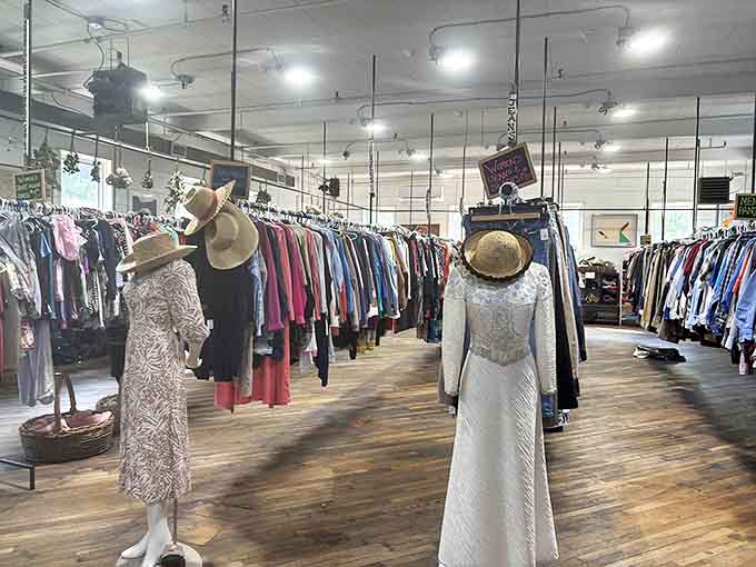 Vintage mannequins stand guard over a treasure trove of clothing, their straw hats and lace dresses whispering tales of garden parties from bygone eras.