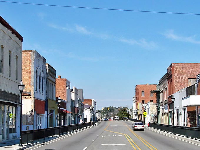 Main Street whispers stories of simpler times, where brick facades and blue skies create the perfect backdrop for unhurried living.