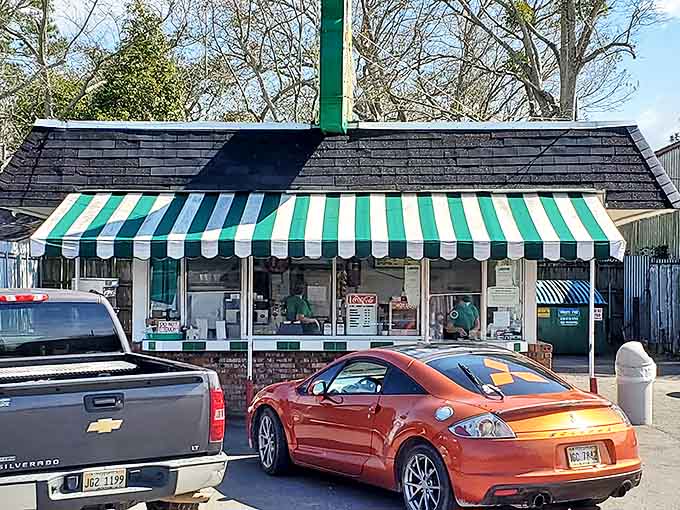 The drive-in window—civilization's perfect invention. Where else can you exchange paper money for a paper boat of happiness without leaving your car's comfort?