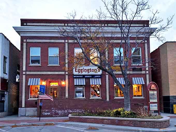 The historic brick facade of Eggington's glows warmly at dusk, its blue and white awnings like beacons calling breakfast lovers home.
