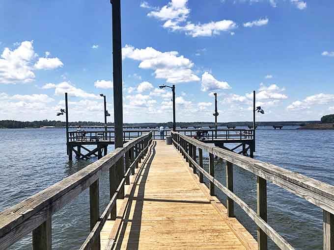 The fishing pier stretches toward possibility, inviting you to wander out where cell service fades and conversations with yourself begin.