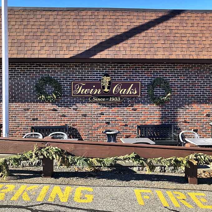 The brick façade of Twin Oaks stands proudly in Cranston, a culinary fortress where Rhode Island food dreams come true since 1933.