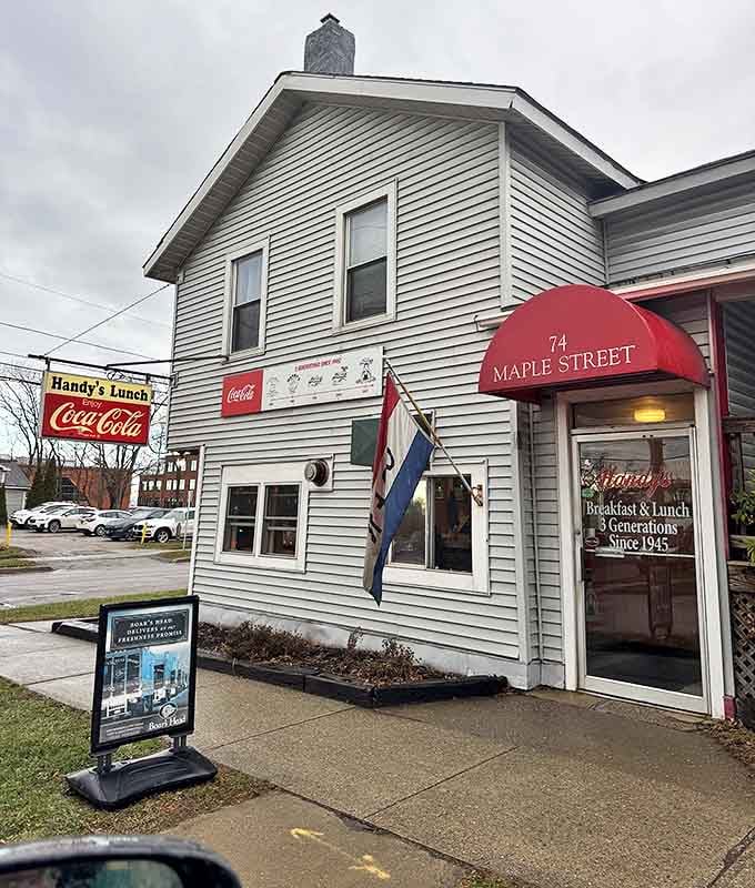 The unassuming white clapboard exterior of Handy's Lunch stands like a time capsule on Maple Street, complete with that iconic Coca-Cola sign beckoning hungry travelers.